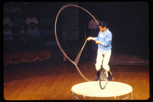 Shanghai acrobats: man on a unicycle with lasso - Digital Commonwealth