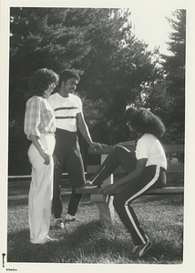 Three Springfield College students by a bench on the campus of ...