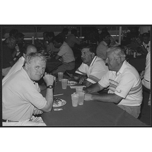 Four adults eat together at a golf course - Digital Commonwealth