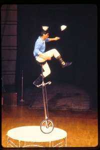 Shanghai acrobats: man balancing on tall unicycle, juggling dishes ...