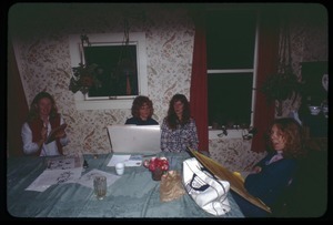 Sue Kramer, Janice Frey, Judy, and Karen Guilette seated around a table ...