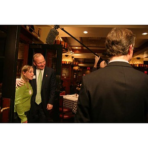 Jack Moynihan poses with a woman in front of a camera crew - Digital ...