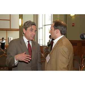 Richard Freeland converses with a man at the Training Future Innovators ...