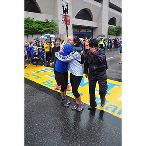 Friends embrace after crossing One Run finish line - Digital Commonwealth