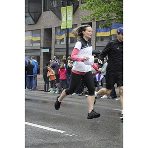 Female runner, holding the hand of a fellow runner, runs in "One Run ...