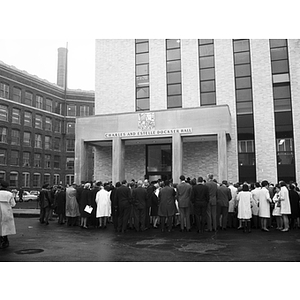 A group of people gather outside Charles and Estelle Dockser Hall ...