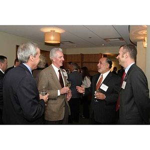 Several people converse at the Torch Scholars dinner - Digital Commonwealth