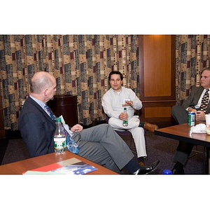 Three men conversing in an entrepreneurship workshop - Digital Commonwealth