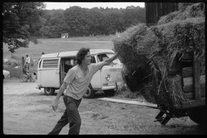 Throwing hay bales on a truck, Montague Farm Commune - Digital Commonwealth