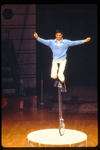 Shanghai acrobats: man balancing on tall unicycle - Digital Commonwealth