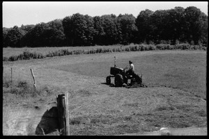 Tony Mathews driving a tractor in the fields, Montague Farm Commune ...
