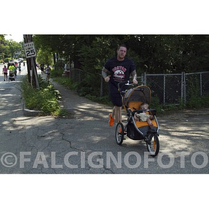 Runner with baby carriage at the StonehamStrong 5K - Digital Commonwealth