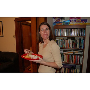 Meghan Allen-Eliason holds a plate of food at the Torch Scholars ...