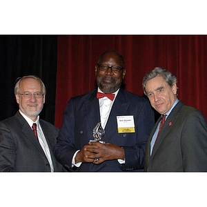 Outstanding Alumni Award recipient Brett Alexander poses with President ...