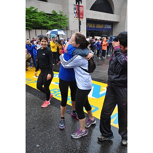 Two women embrace at One Run finish line - Digital Commonwealth