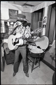 Tom Shipley with guitar, smoking - Digital Commonwealth