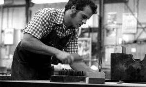 Rodney Hunt worker hammering - Digital Commonwealth