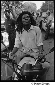 Dillinger (reggae musician), seated on a motorcycle - Digital Commonwealth