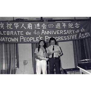 Man and woman address an audience at the Chinese Progressive ...