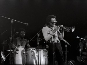 Miles Davis in performance: James Mtume (congas) and Miles Davis ...