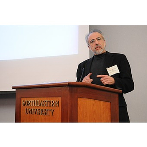 Professor Joshua Jacobson gesturing during a speech - Digital Commonwealth