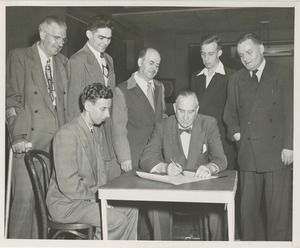Signing papers - Digital Commonwealth