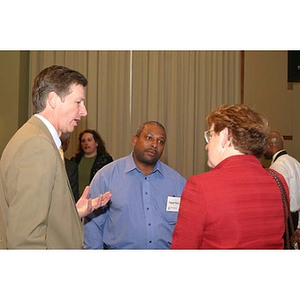 Roger Blethen speaks with Reggie Plaisir and Jean Tempel at the ...