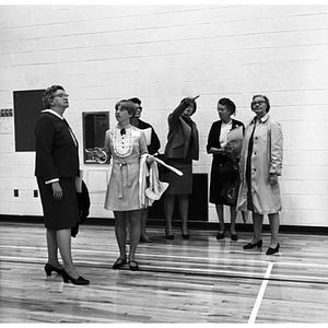 A group of women survey a room in Dockser Hall - Digital Commonwealth